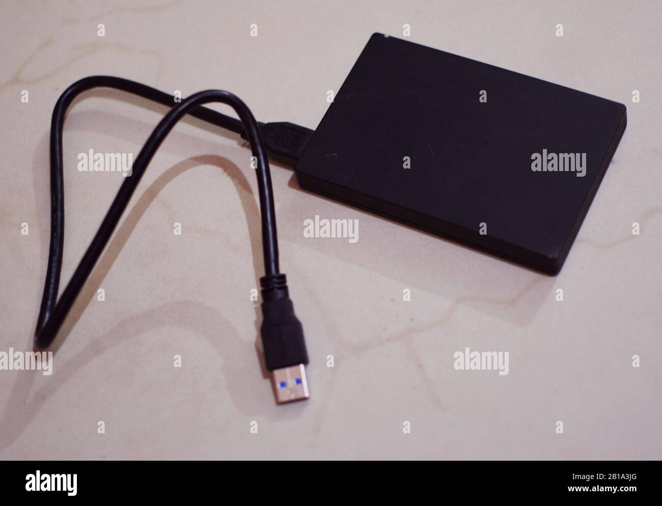 A mini grey colored external hard drive Stock Photo - Alamy