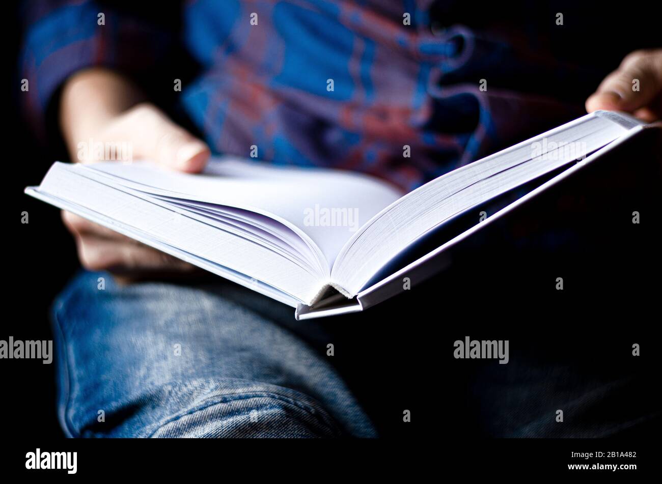 White book with clean pages in the hands of a man Stock Photo - Alamy