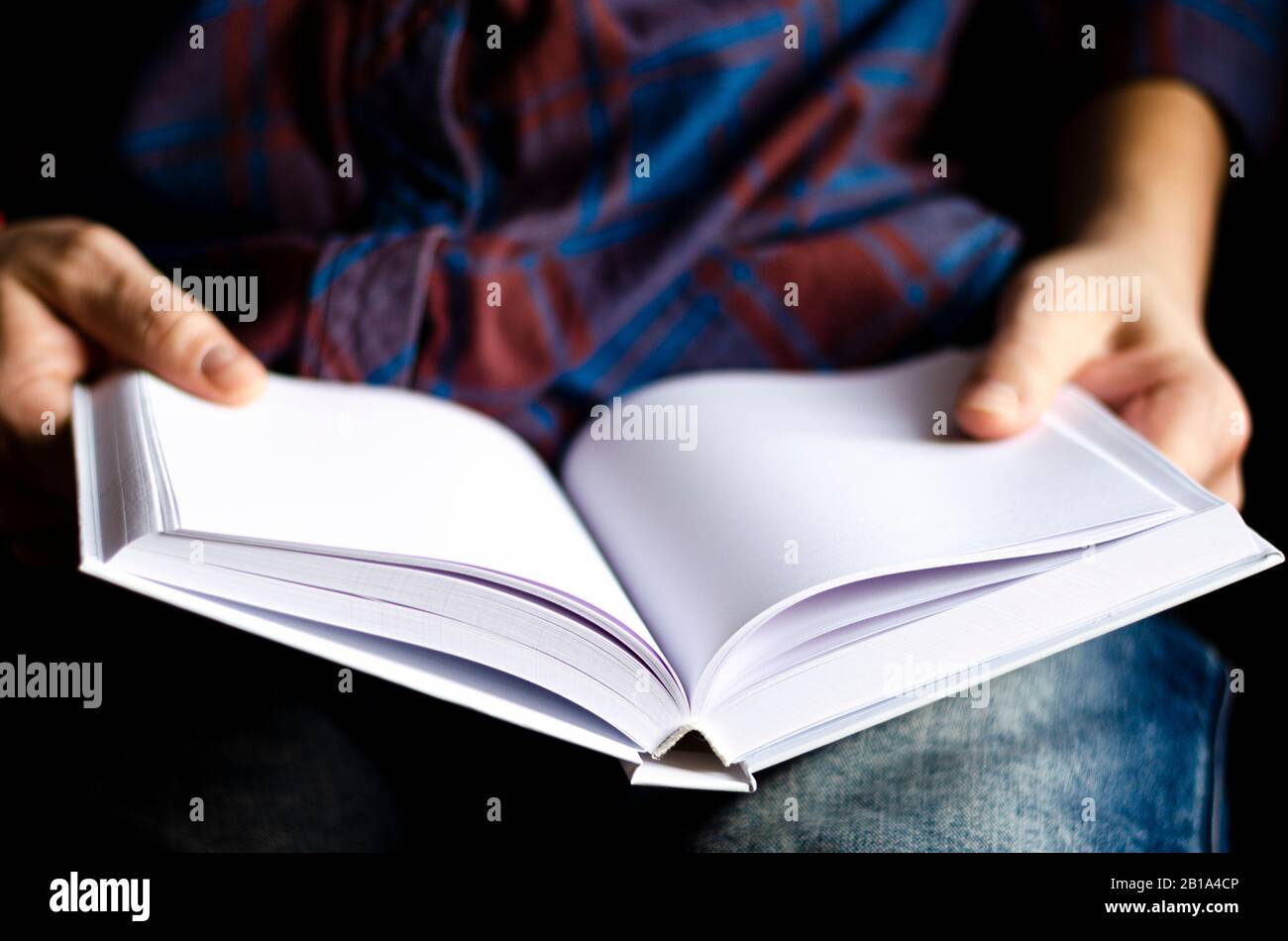 White book with clean pages in the hands of a man Stock Photo - Alamy