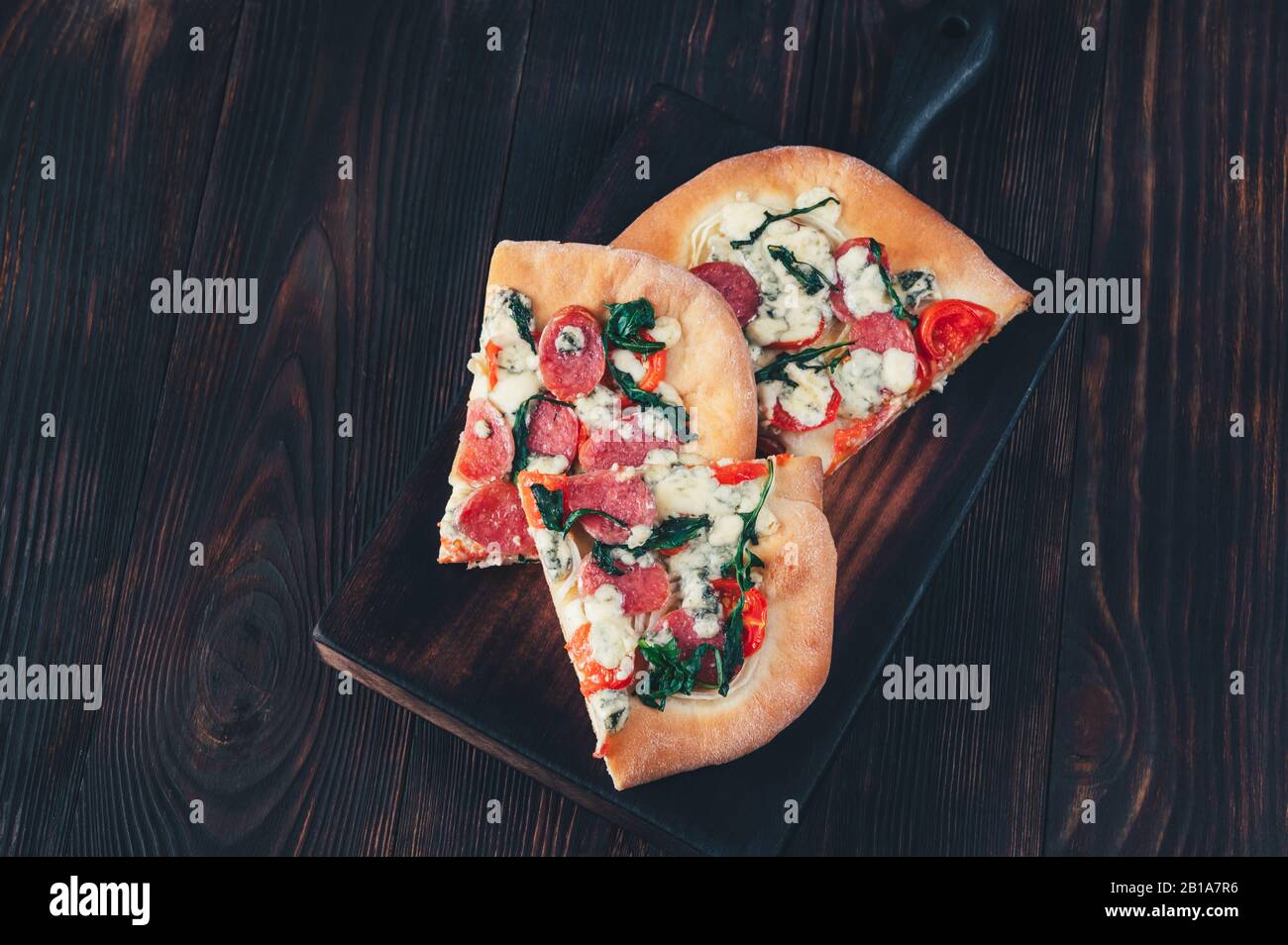 Spanish coca with blue cheese, fuet and arugula Stock Photo - Alamy