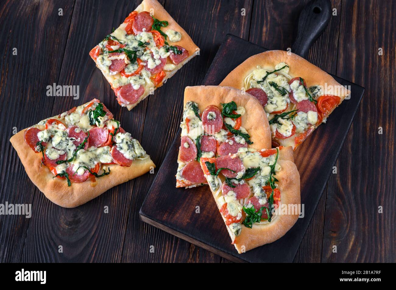 Spanish coca with blue cheese, fuet and arugula Stock Photo - Alamy