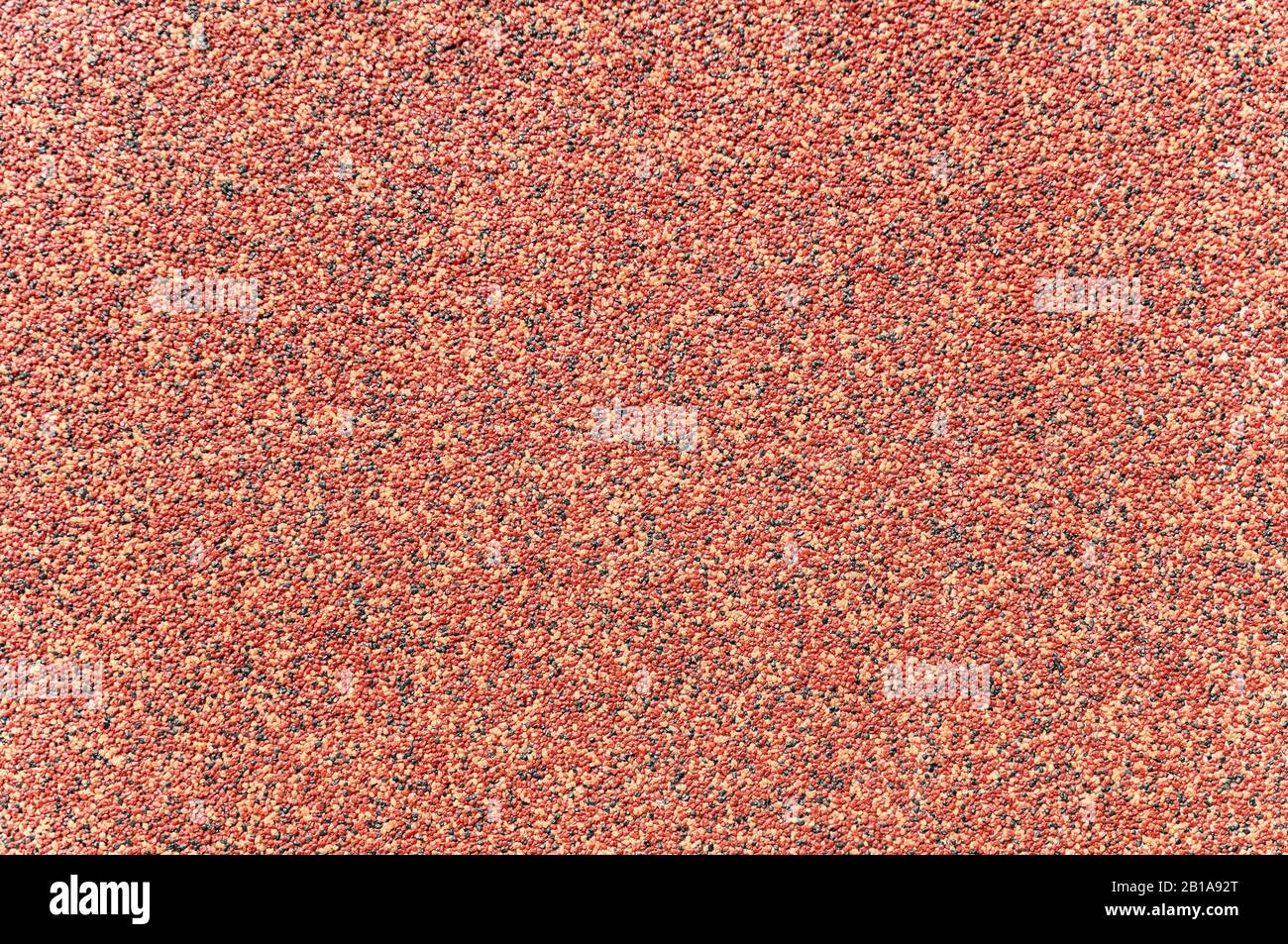 Colorful sand texture. Small grains of sand of red, black and beige ...