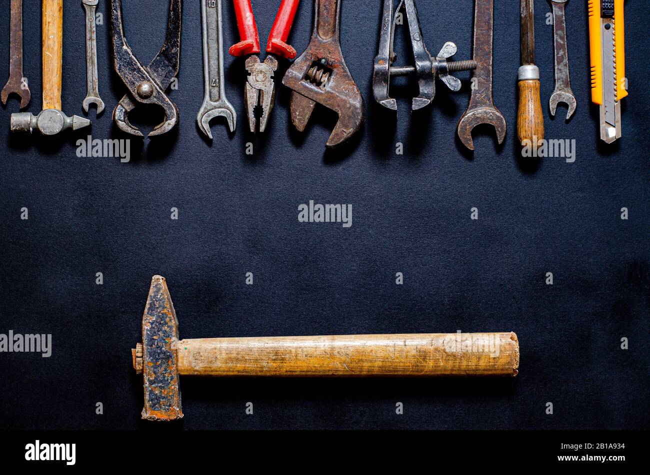 Tools for repair and reconstruction in home conditions lie on a black ...