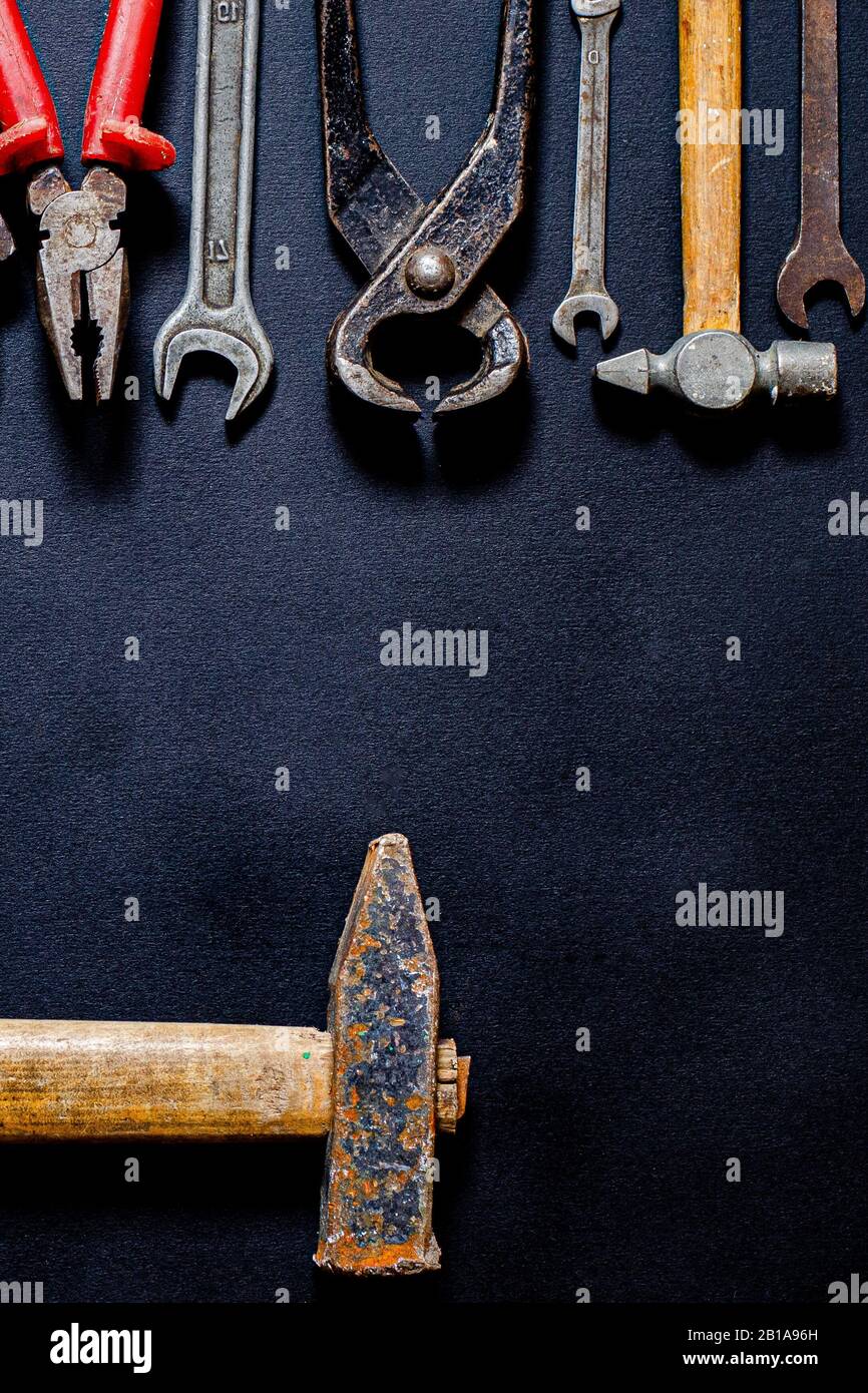 Tools for repair and reconstruction in home conditions lie on a black ...