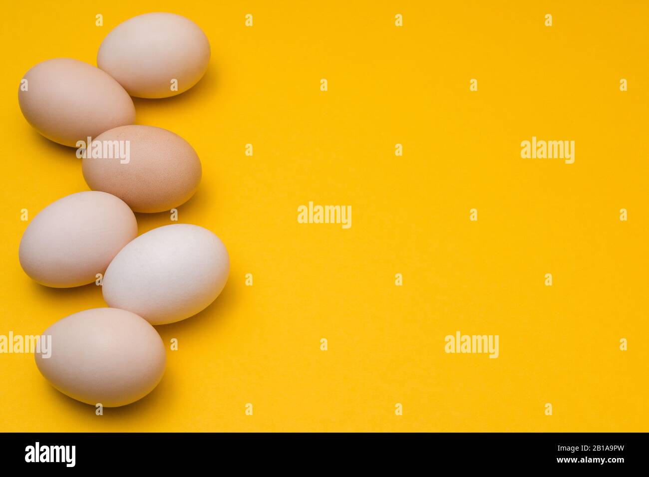 easter eggs natural color on a yellow background with copyspace. easter ...