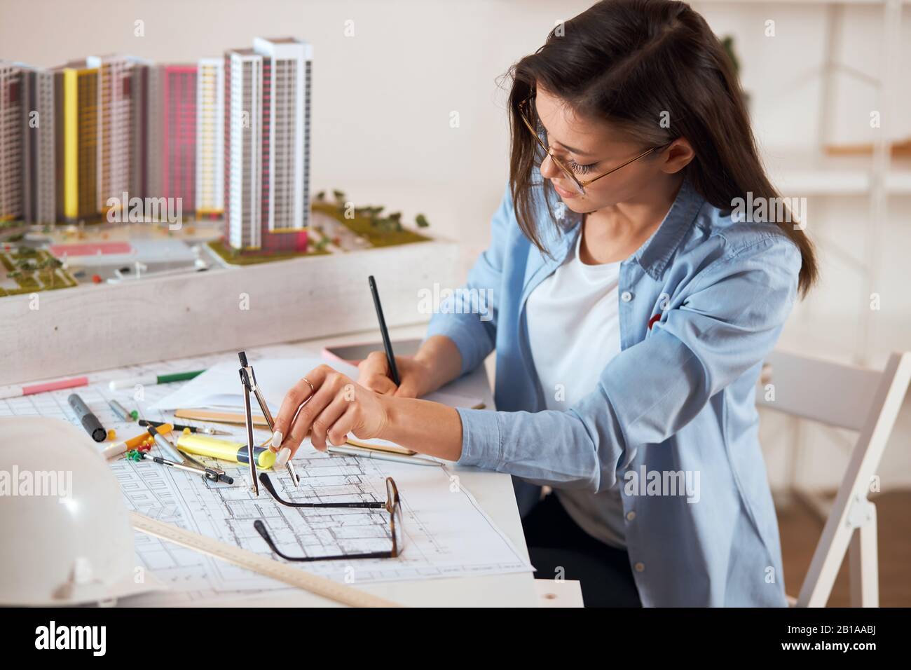 young professional architect concentreated on working in the office ...