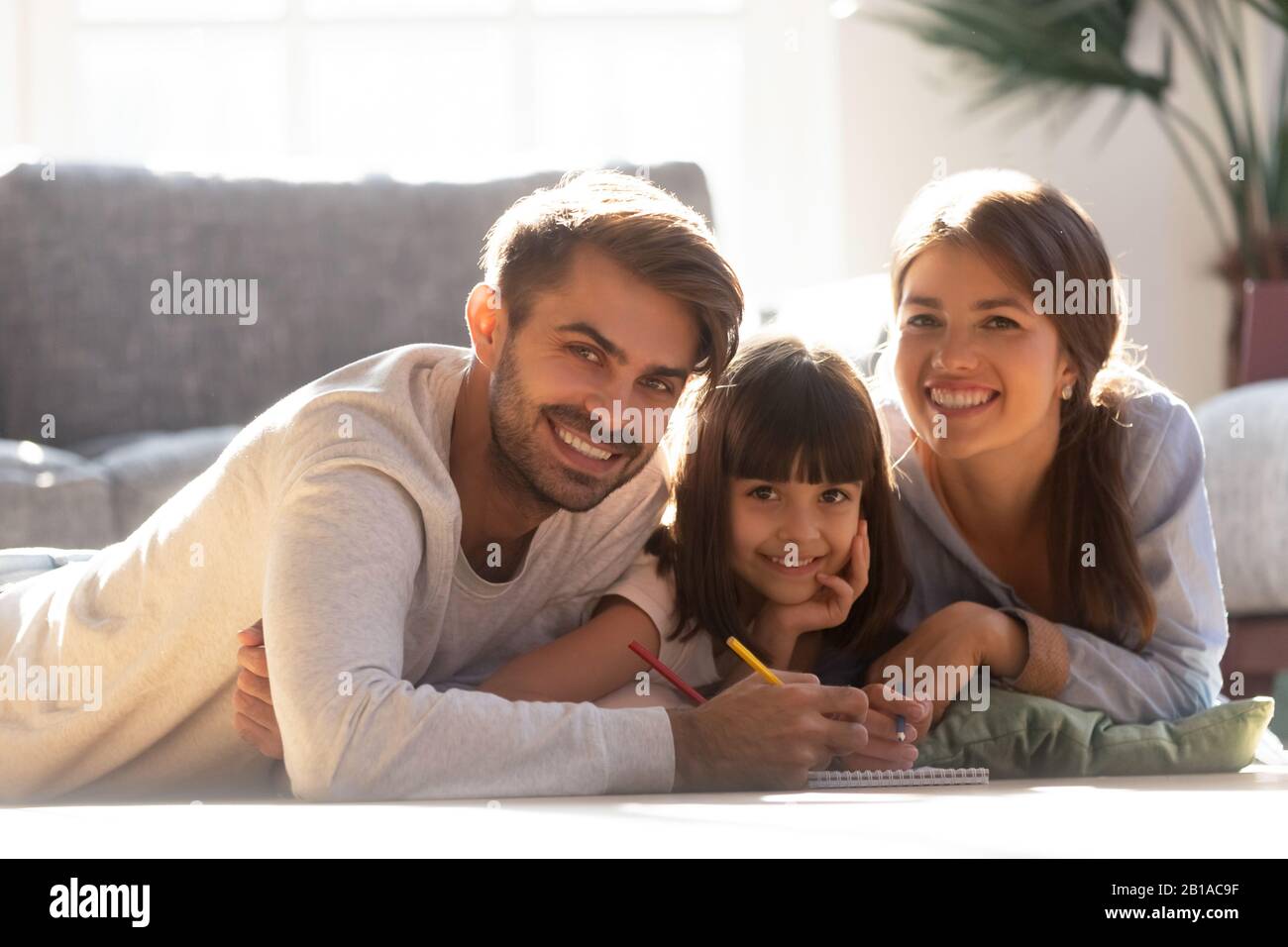 Portrait of happy parents drawing with cute preschooler daughter Stock ...