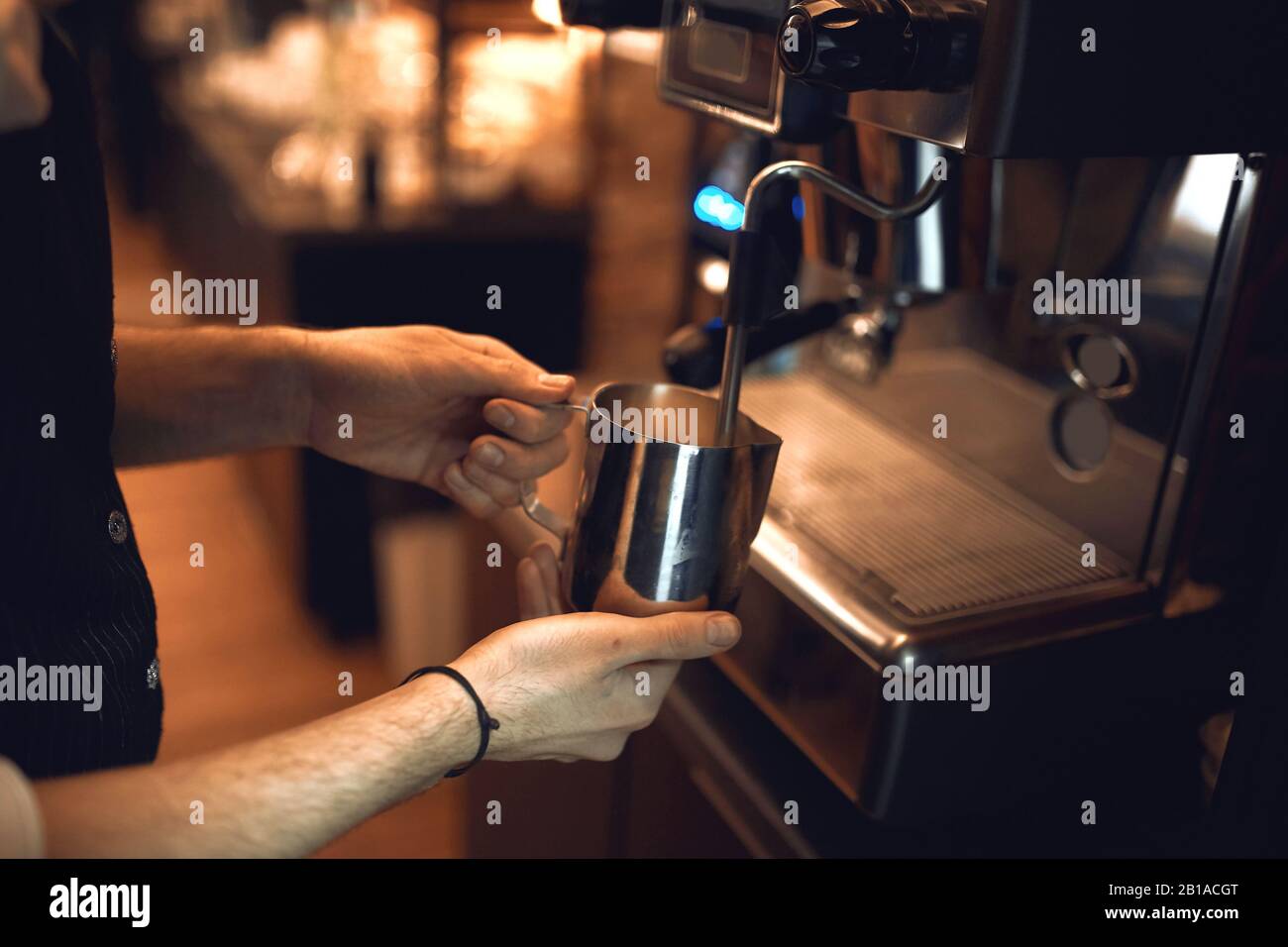 preparation method. male barista preparing coffee using machine in the ...