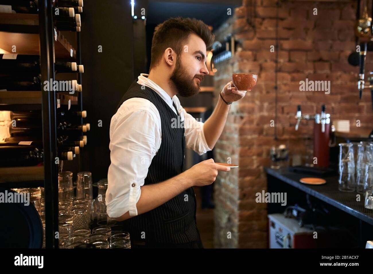 young bearded barista advising customers to buy, drink, taste new tasty ...