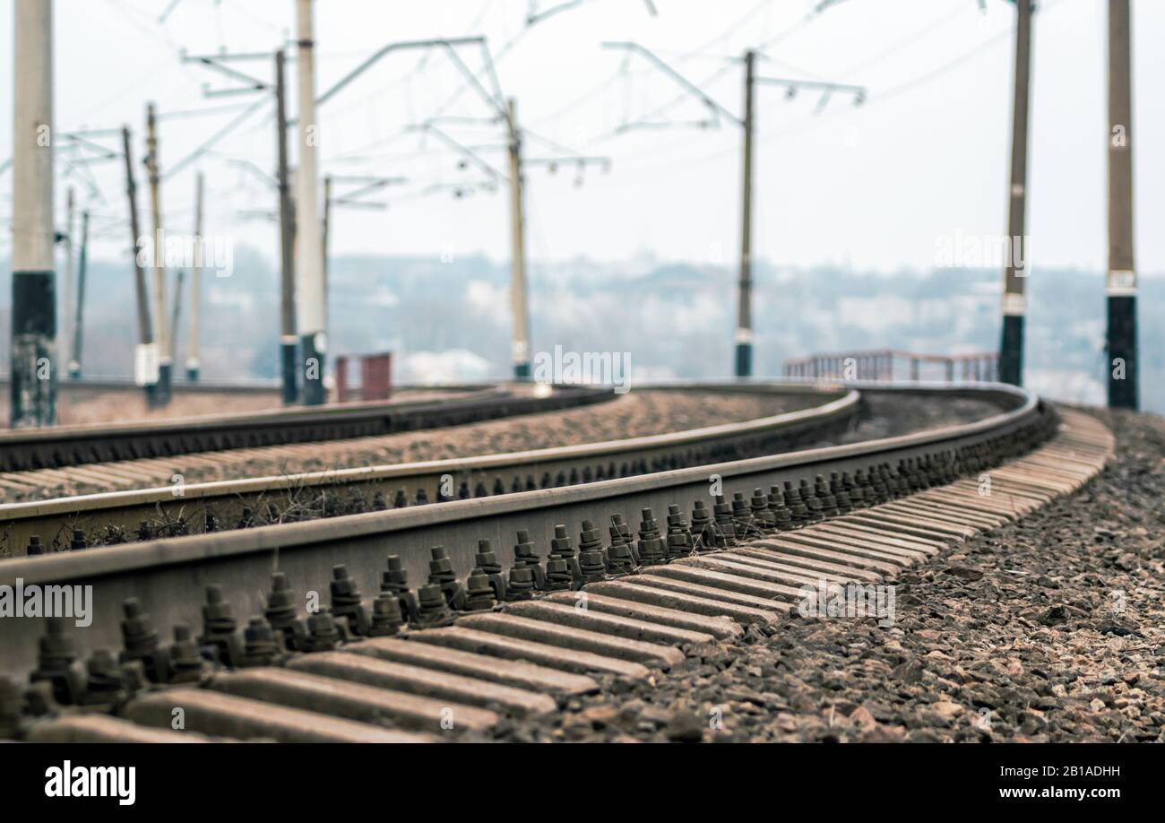 old railroad rails and poles with wires without a train without people ...