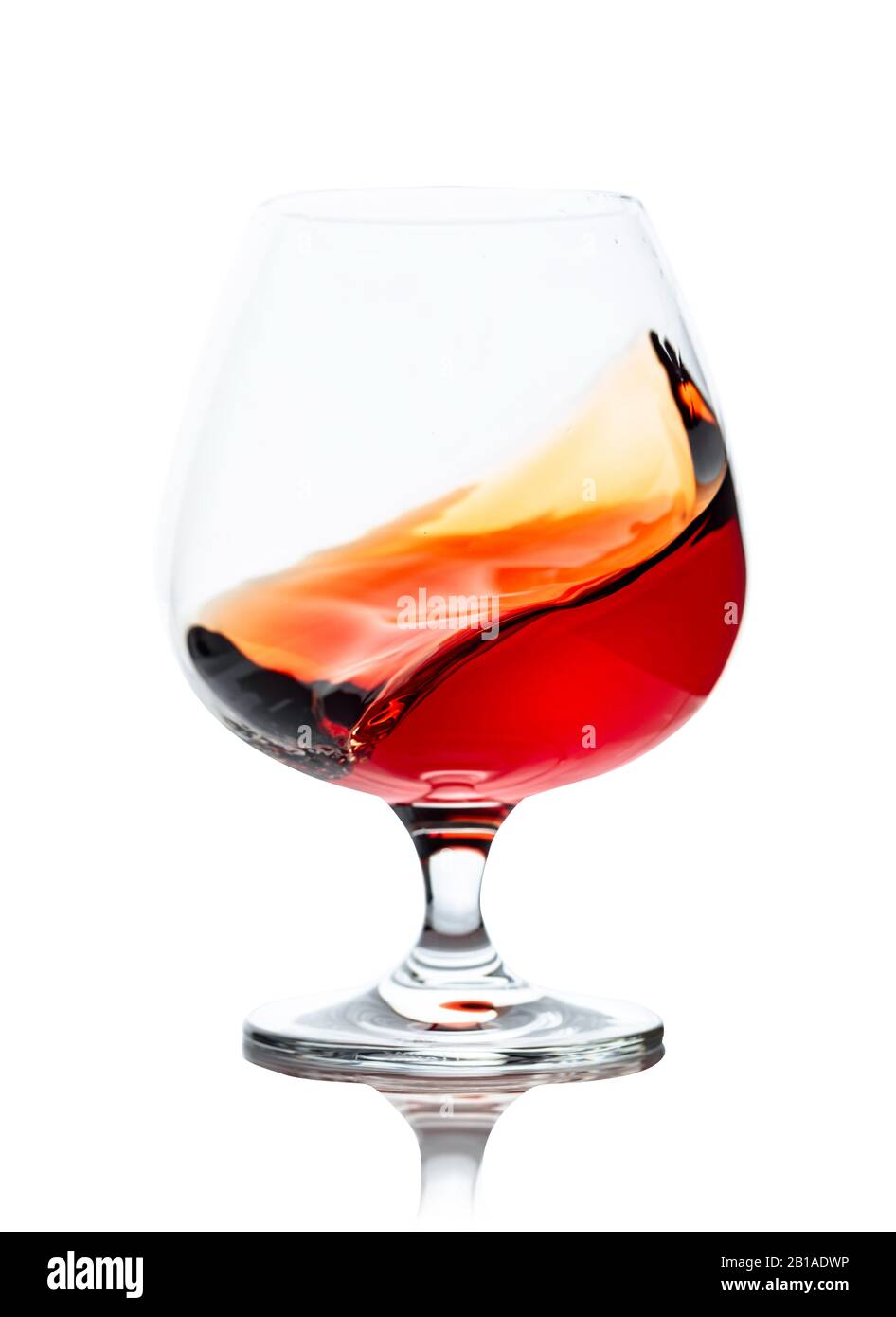 Splash of cognac in glass, isolated on white background. Saved clipping ...