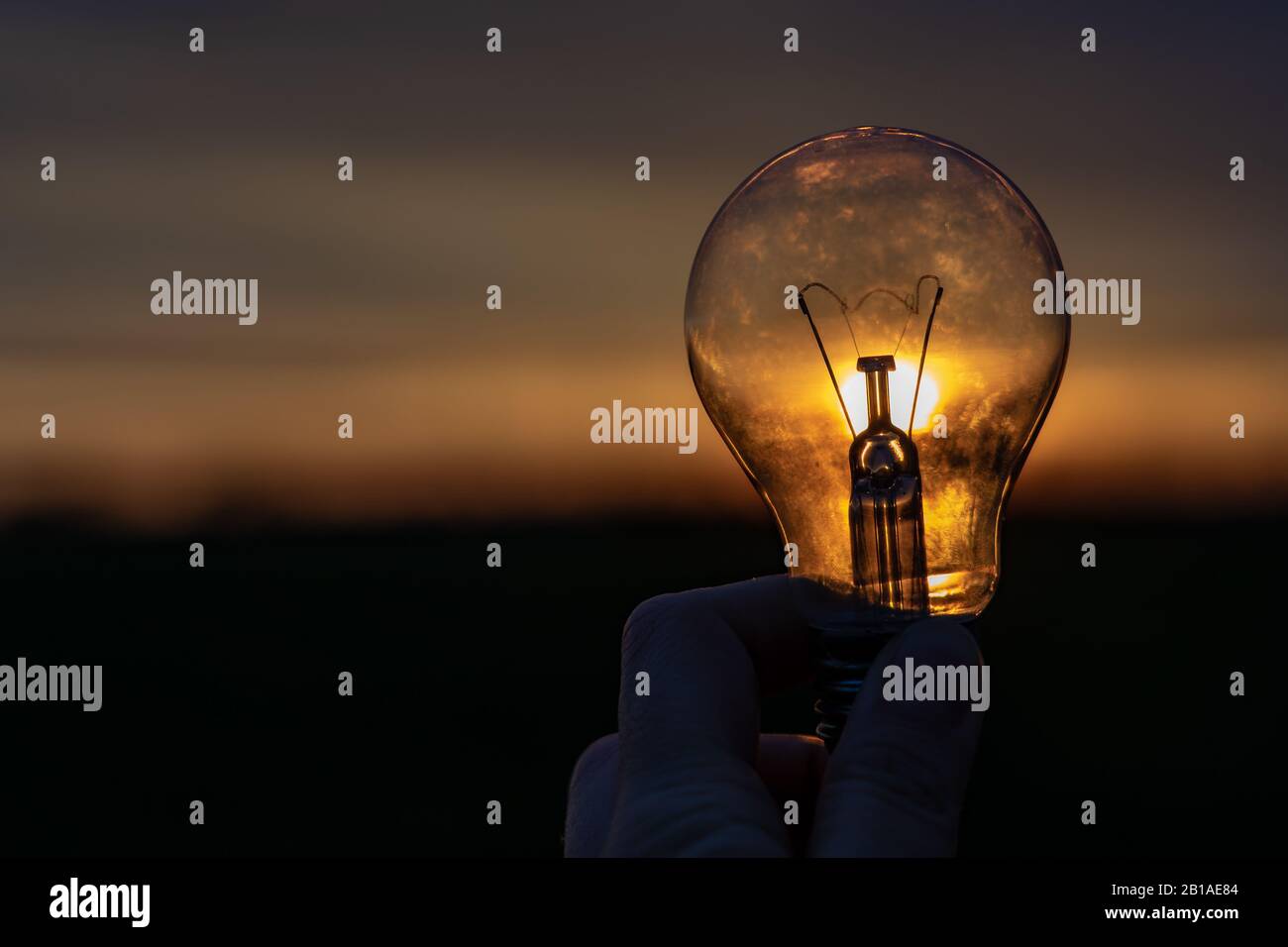 sunset through light bulb concept of renewable energy Stock Photo - Alamy