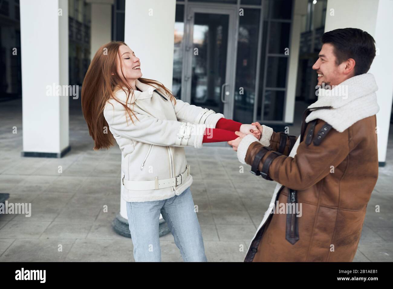 funny couple entertaining in the street, close up side view photo. copy ...