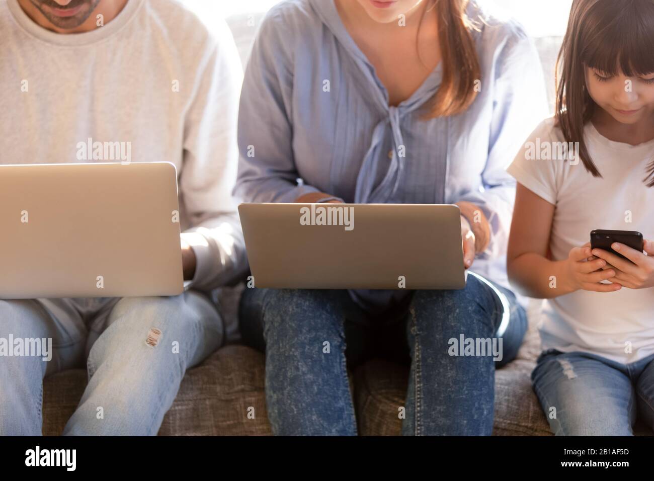 Family with child busy using gadgets at home Stock Photo - Alamy