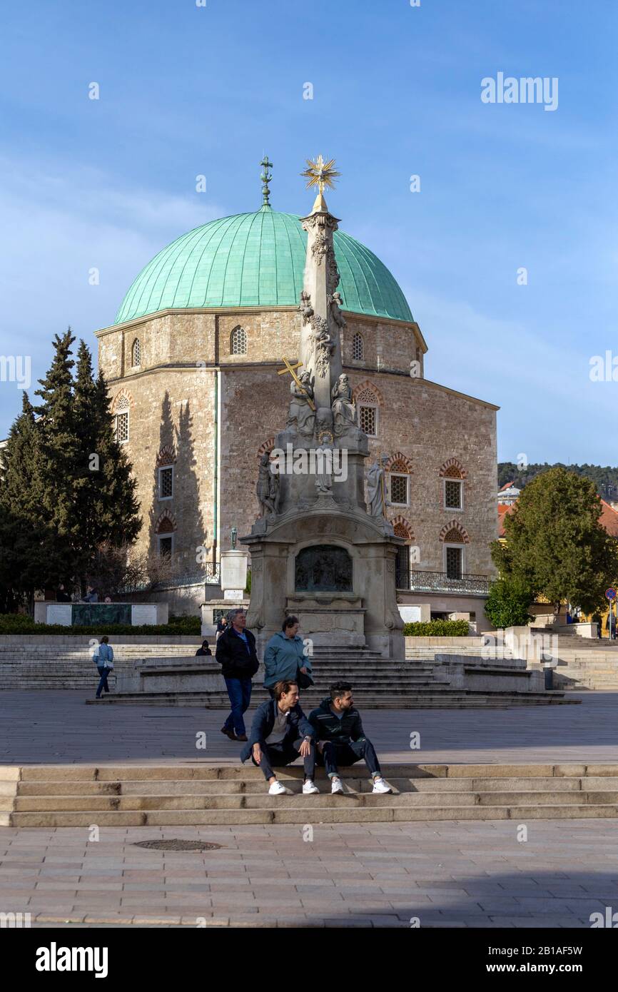 Pecs, Hungary - 02 22 2020: Holy Trinity statue with the mosque of ...