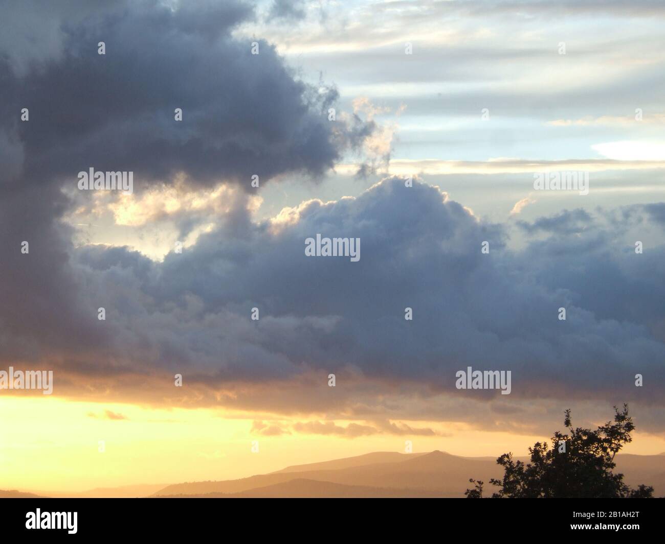 Moody clouds during sunset Stock Photo - Alamy