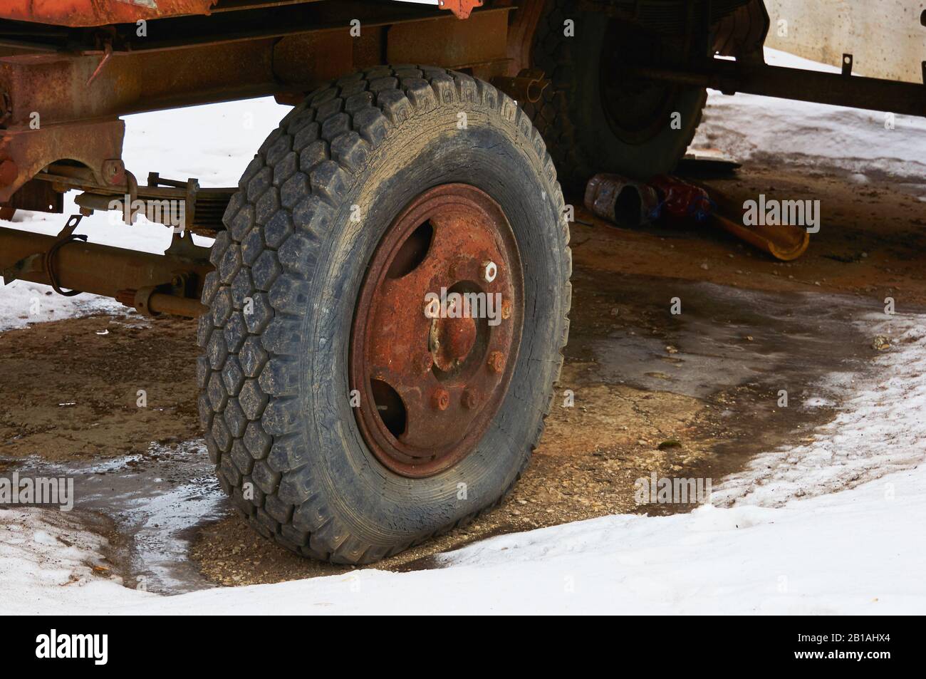 Old cracked deflated tire on a large machine Stock Photo - Alamy