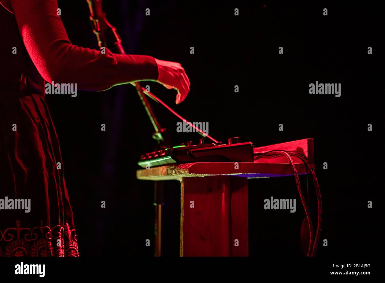 A closeup side profile shot of a musician performing on stage in ...