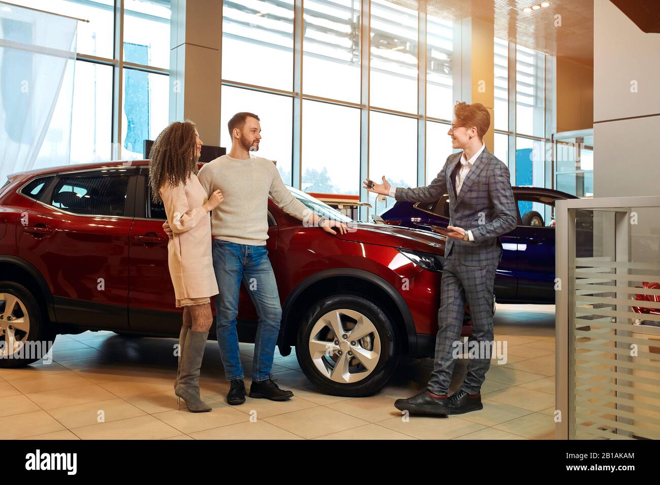 new car review, young dealer specialist working with clients at ...