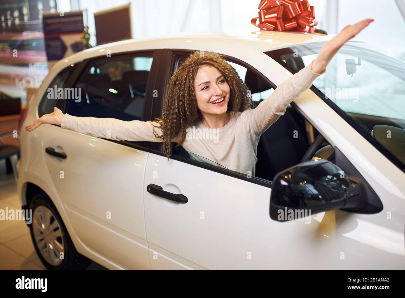 positive smiling beautiful girl sticking out the car window celebrating ...