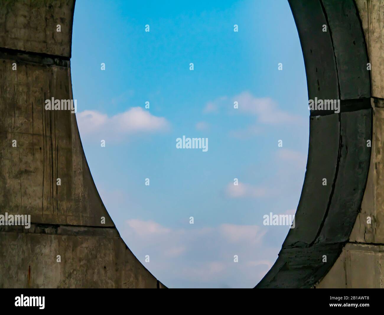 Sky with clouds through a round concrete window Stock Photo - Alamy