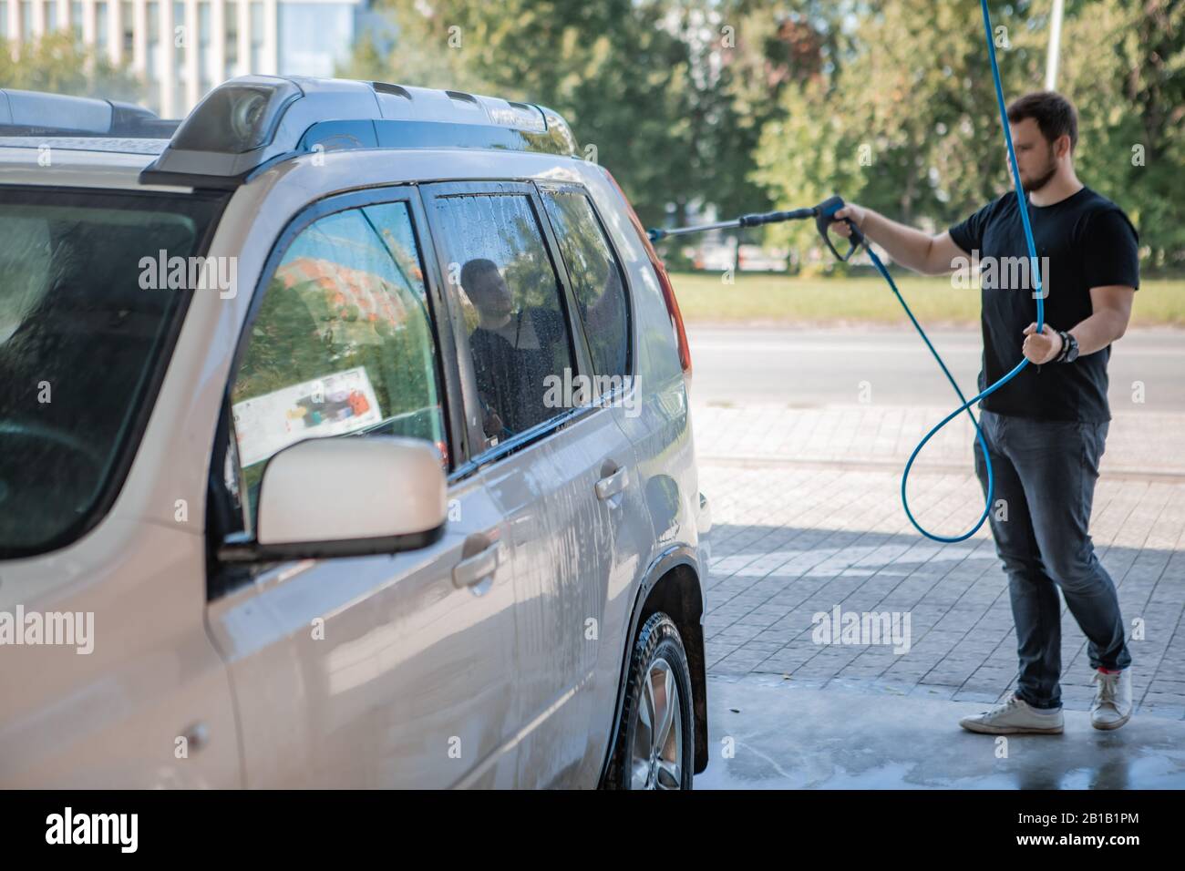 strong man washing car at self carwash outdoors Stock Photo - Alamy