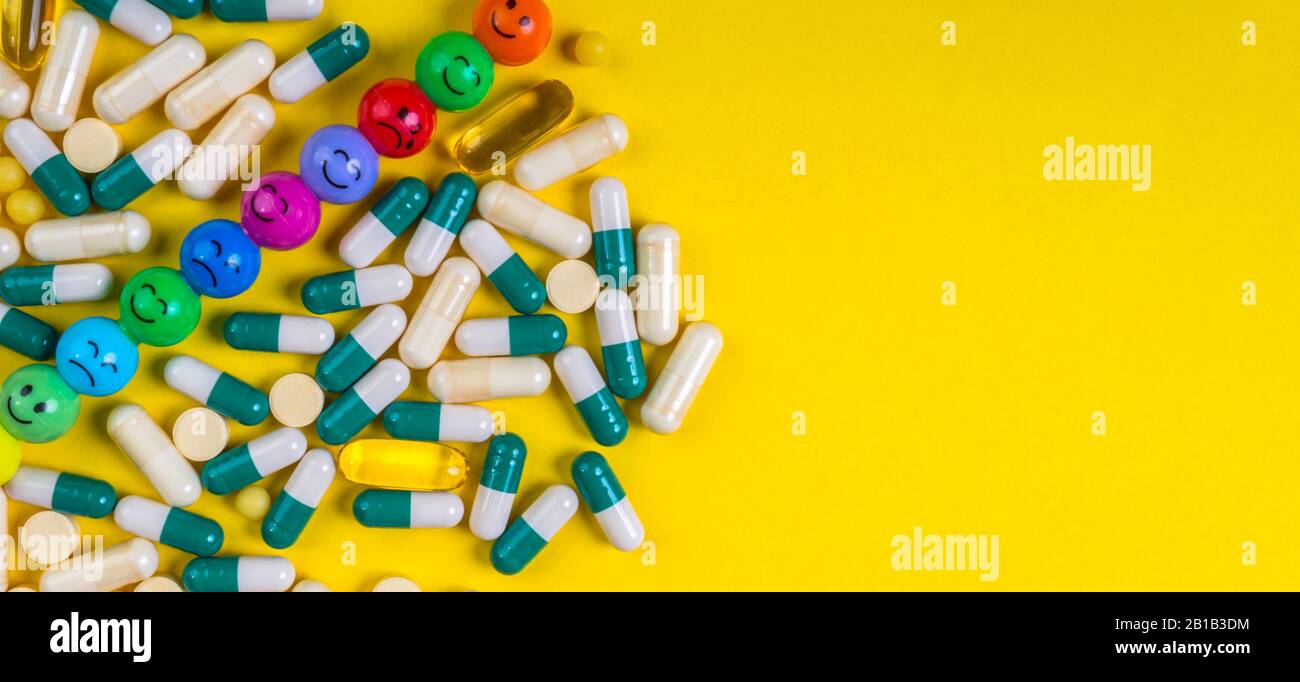 Multi color pills, tablets and capsules with colorful funny faces with ...