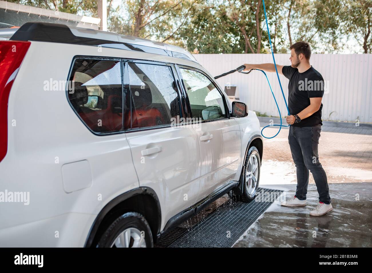 strong man washing car at self carwash outdoors Stock Photo - Alamy