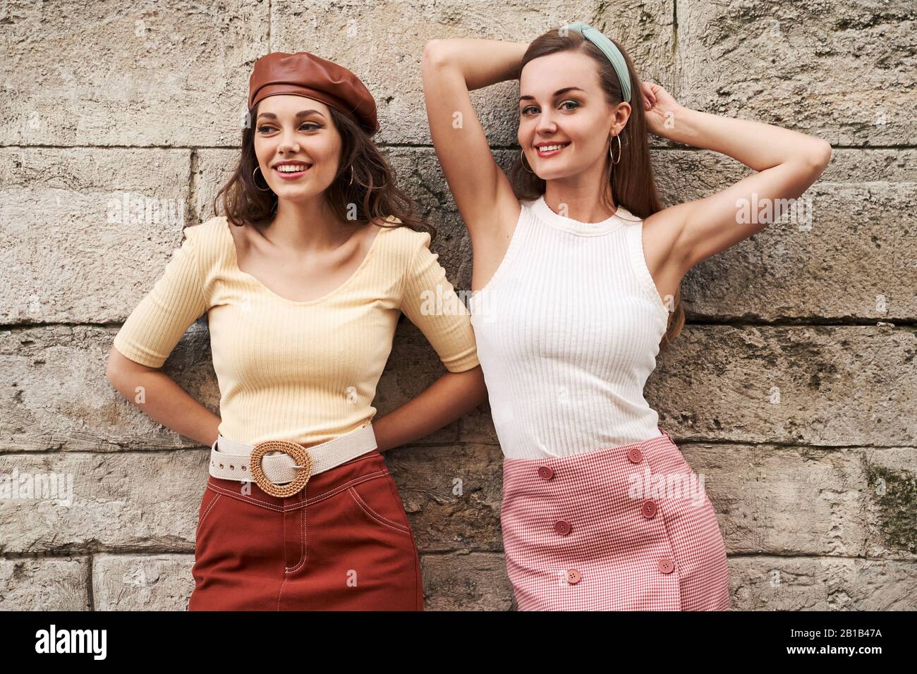 Young beautiful girls dressed in retro vintage style enjoying the old ...