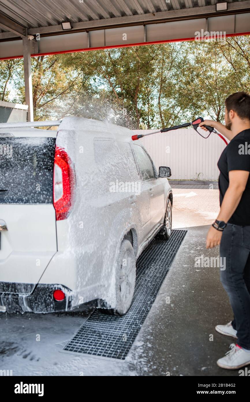 strong man washing car at self carwash outdoors Stock Photo - Alamy