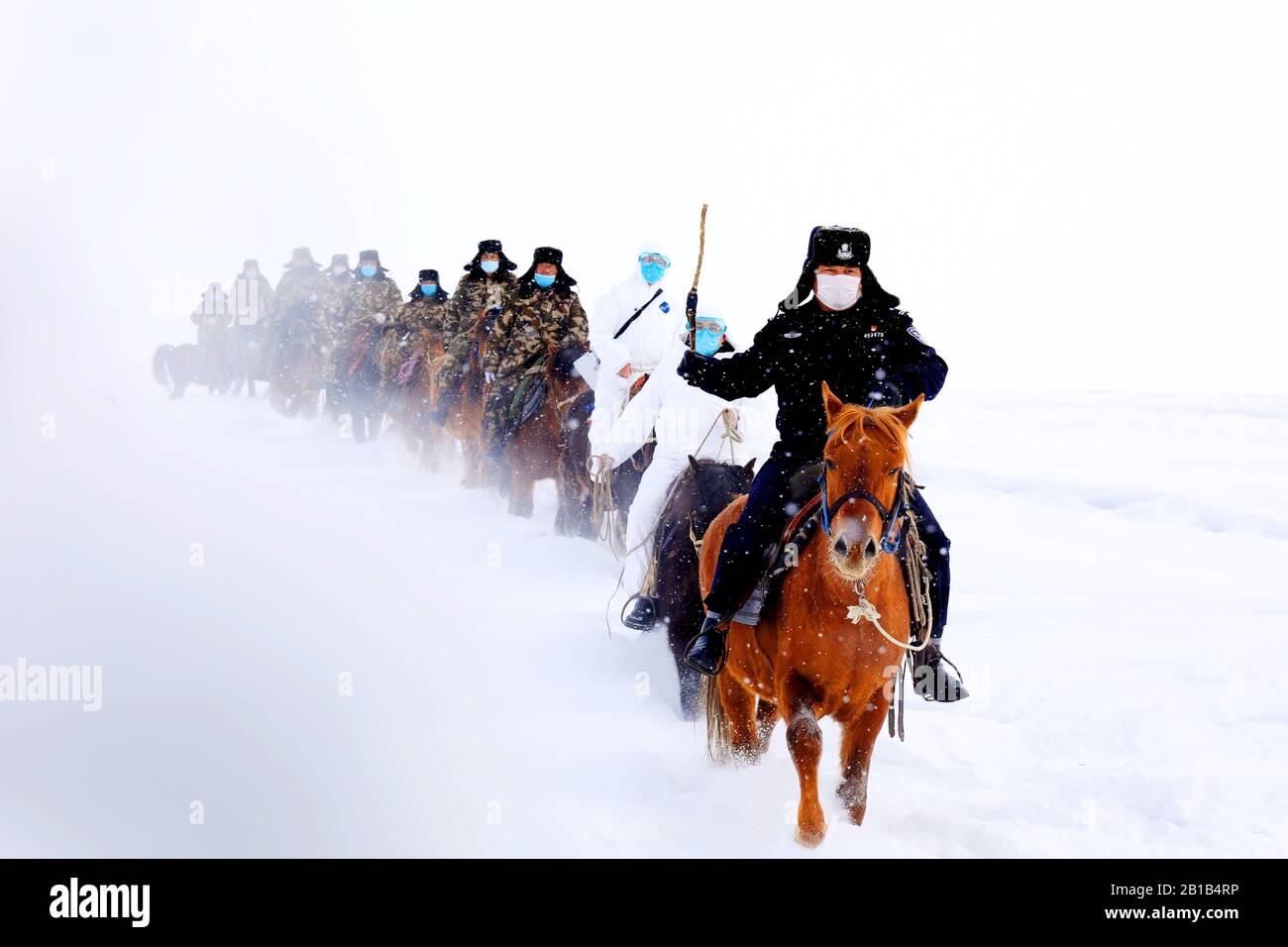 Chinese police officers, border guards and medical workers ride horses ...
