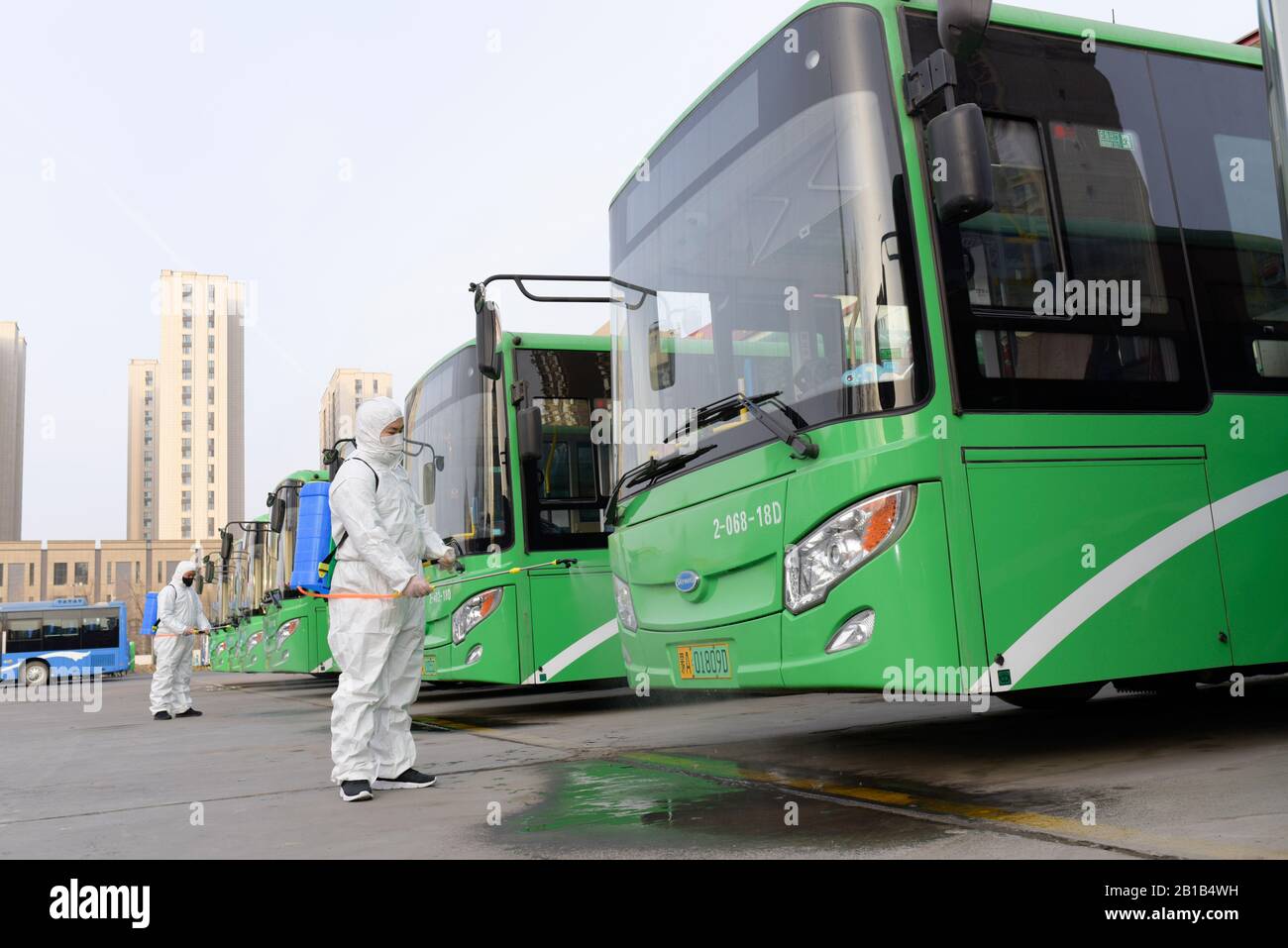Hohhot City, China. 24th Feb 2020. Chinese workers disinfect buses to ...