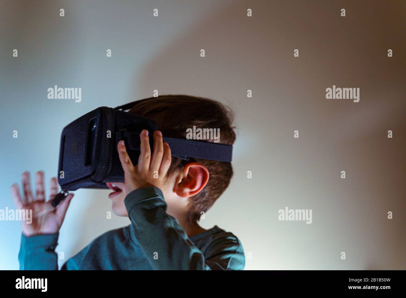 Child using new Virtual Reality, VR cardboard glasses Stock Photo - Alamy