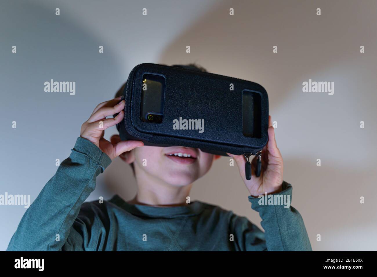 Child using new Virtual Reality, VR cardboard glasses Stock Photo - Alamy