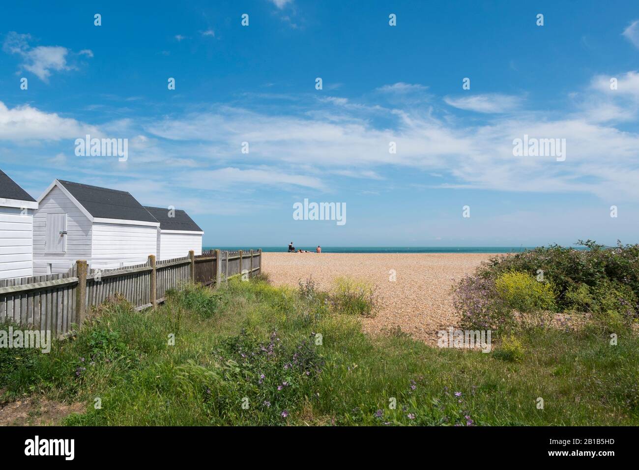 Traditional white beach huts on the beach at Walmer, Deal, Kent, UK ...