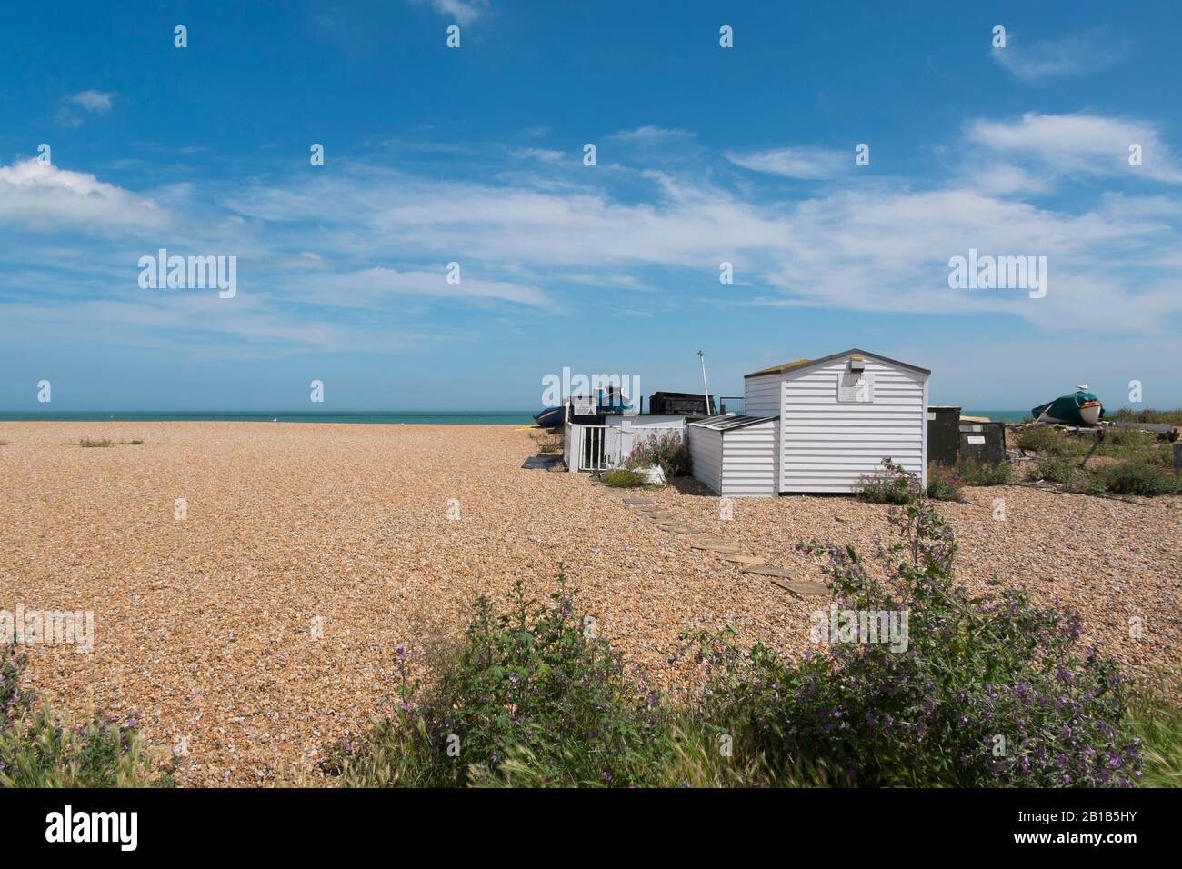 Traditional white beach huts on the beach at Walmer, Deal, Kent, UK ...
