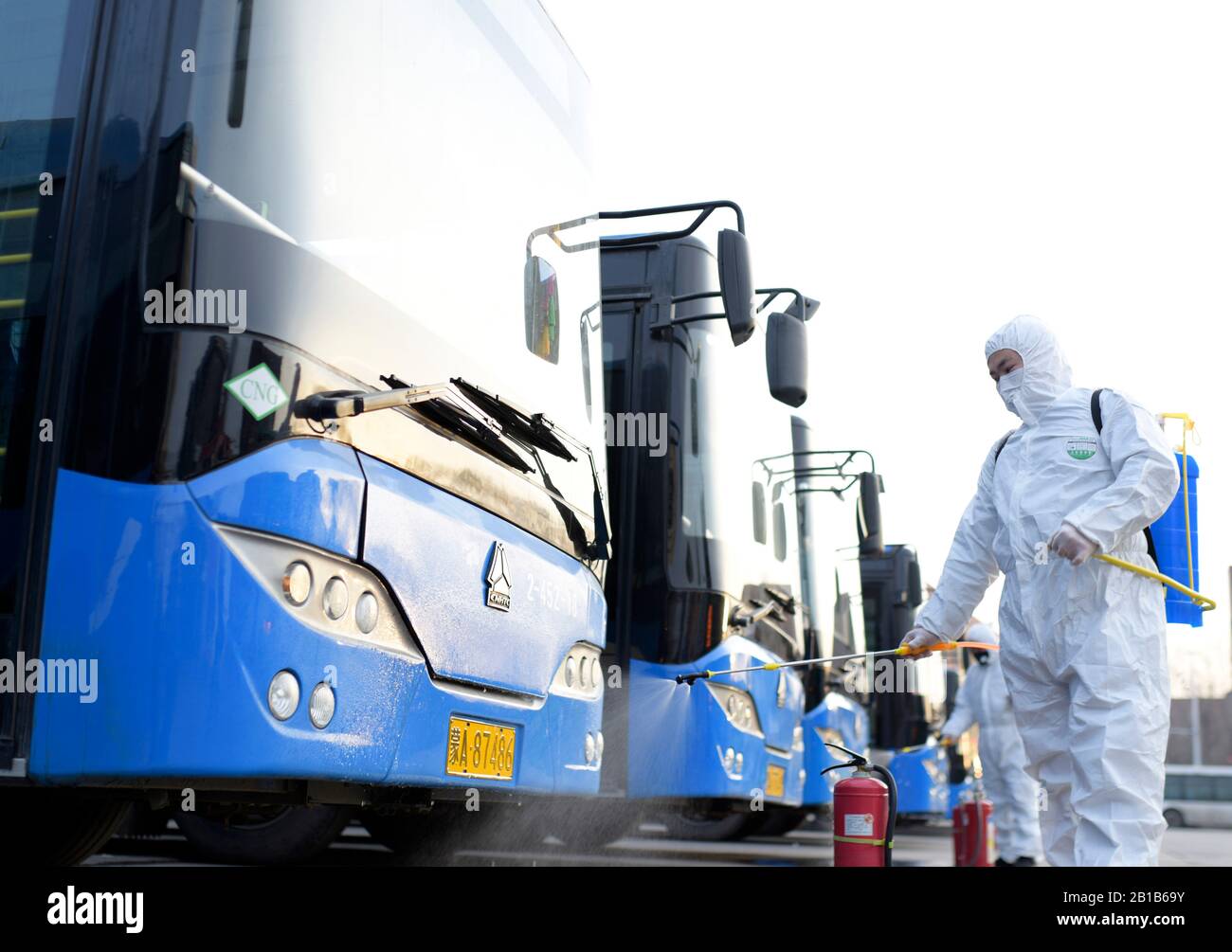 Hohhot City, China. 24th Feb 2020. Chinese workers disinfect buses to ...