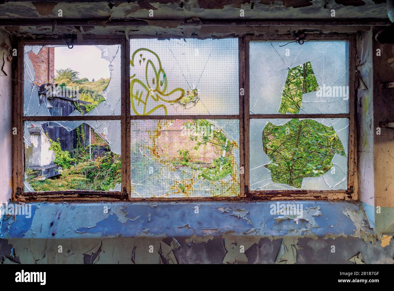 Abandoned, neglected urban buildings, with graffiti and smashed windows ...