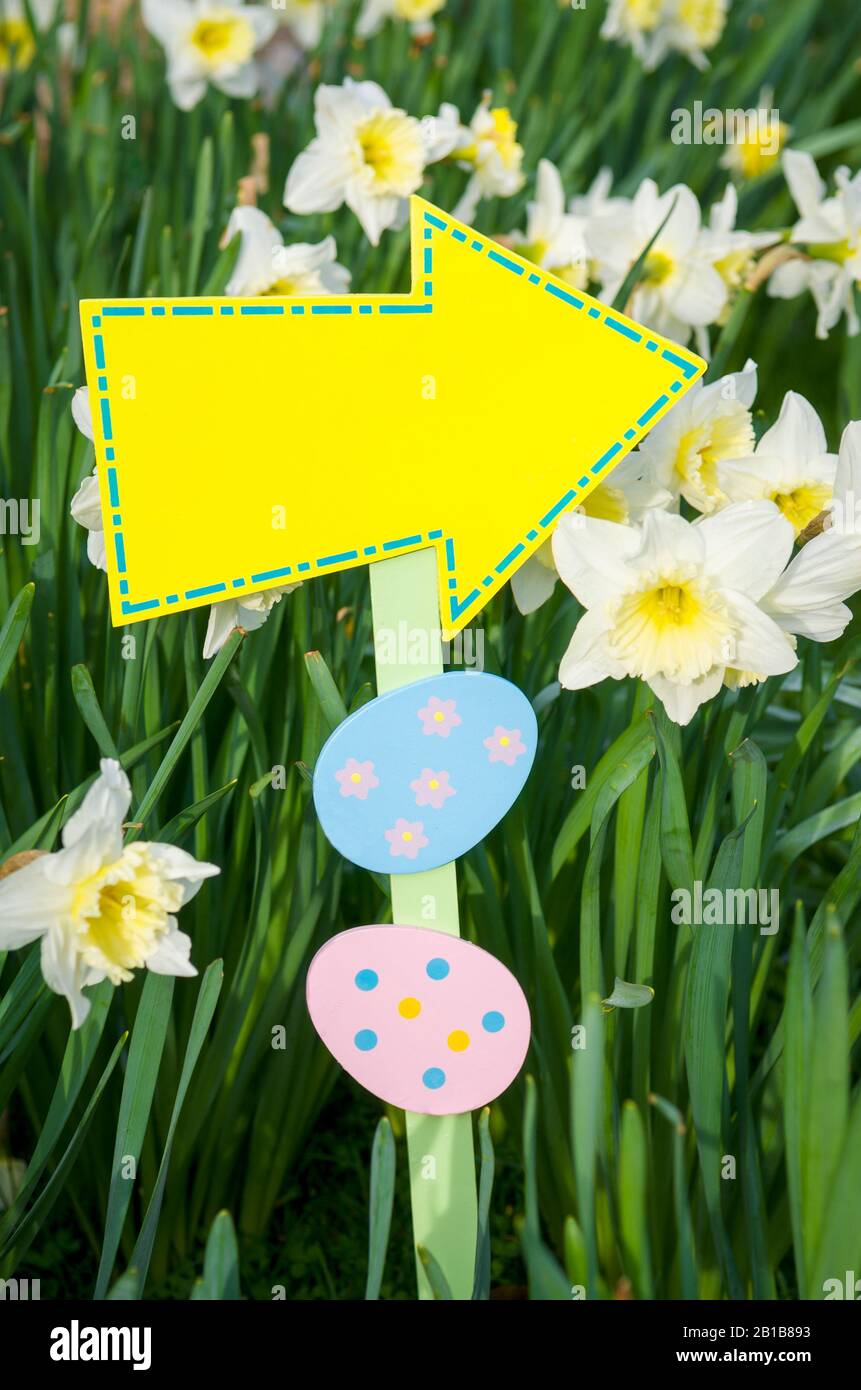 Colorful Easter sign pointing to a spring flower garden Stock Photo - Alamy
