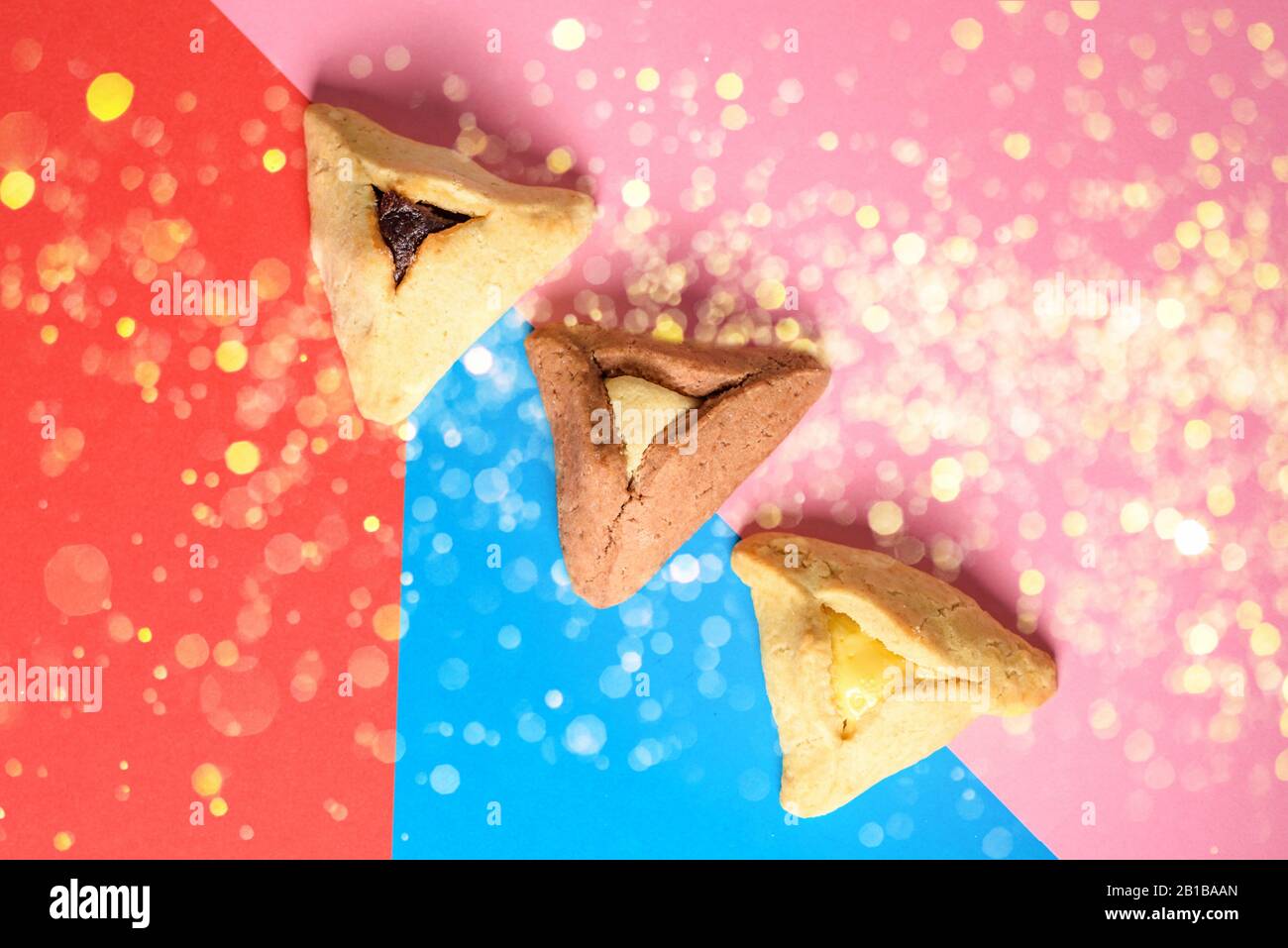 Purim holiday concept. Creative arrangement of variety Hamantash on red ...