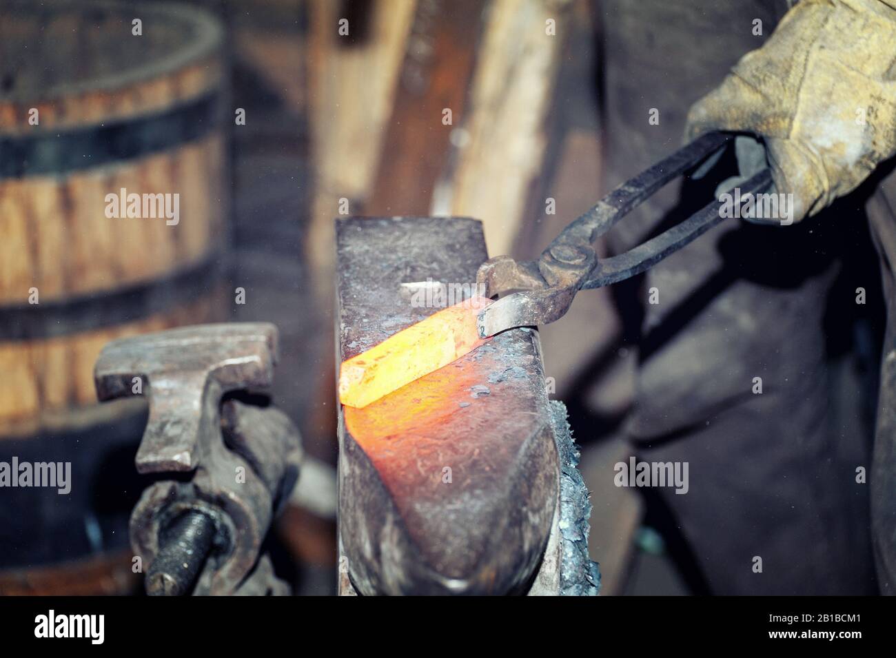 Blacksmith working metal with hammer on the anvil in the forge Stock ...