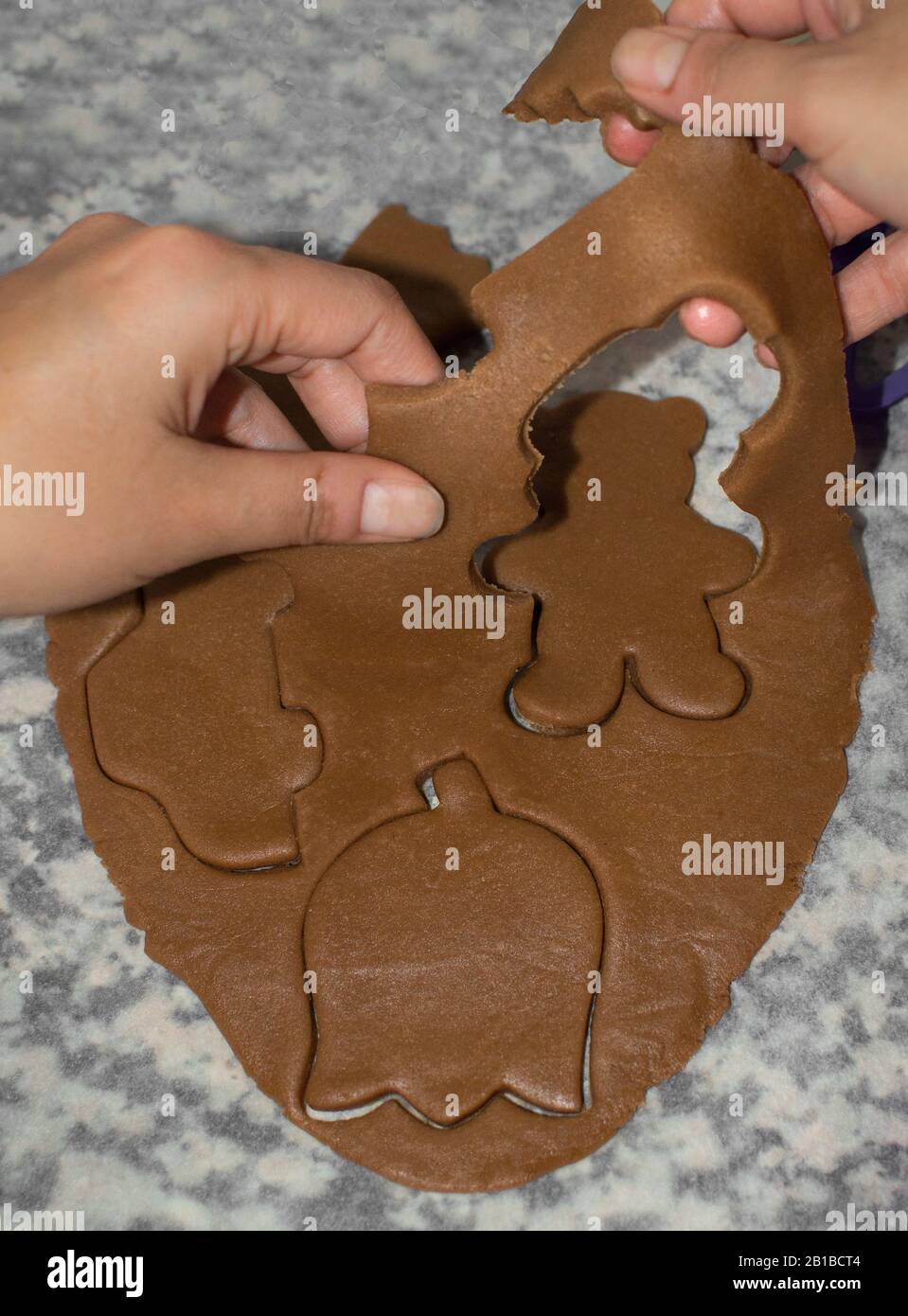 Top view of hands making cookies with different shapes. Using funny ...