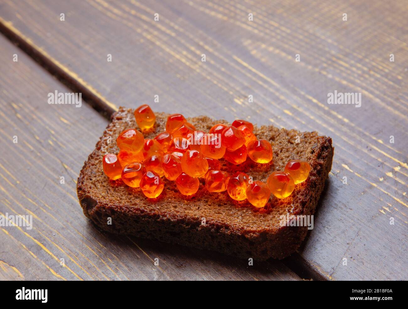 small salmon caviar sandwich on wooden table ( red caviar ) . Russian ...