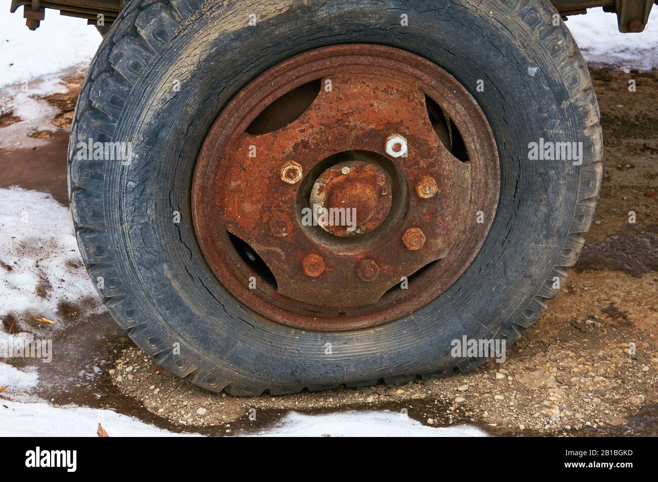 Old cracked deflated tire on a large machine Stock Photo - Alamy