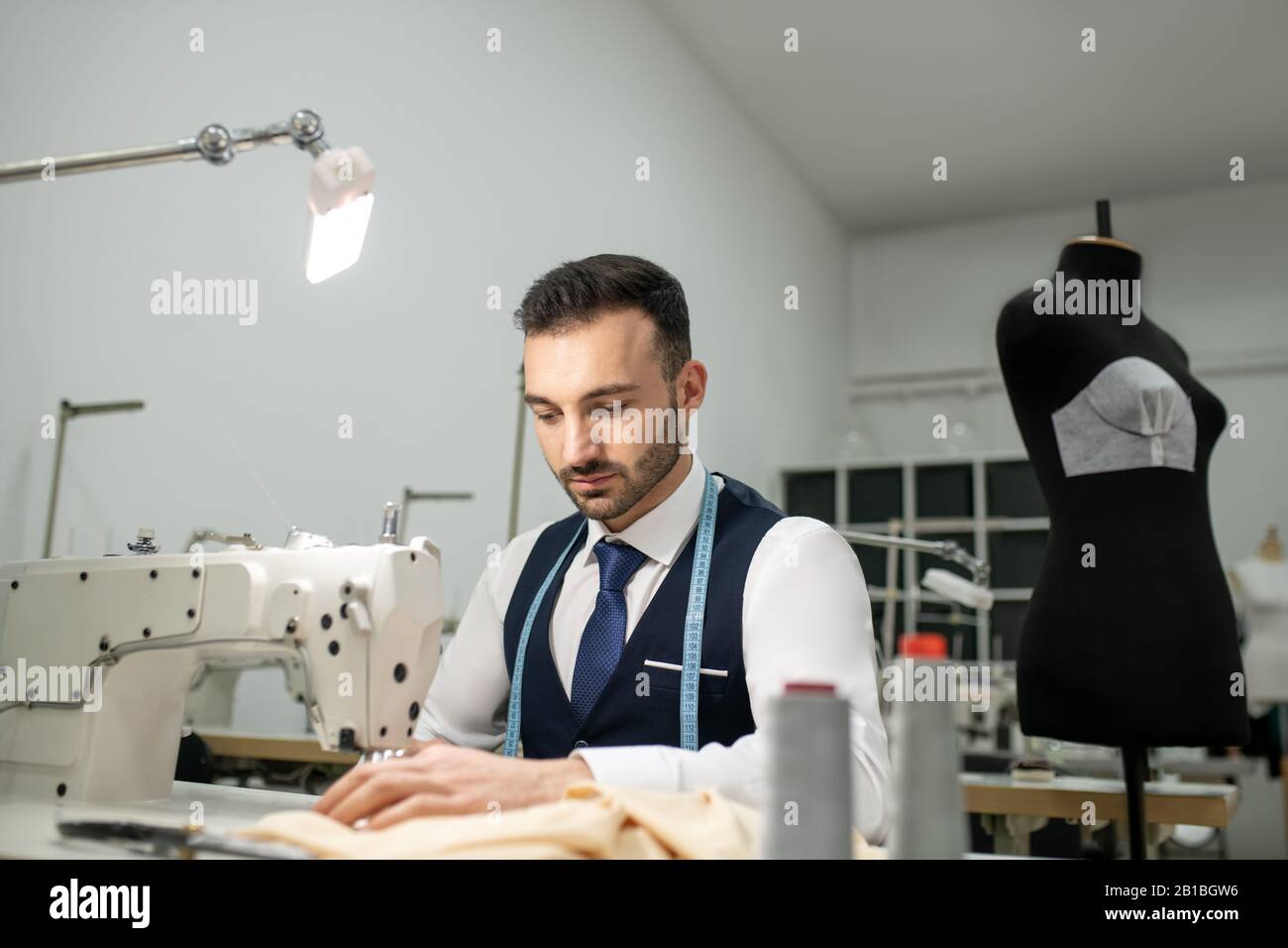 Tailor sitting hi-res stock photography and images - Alamy