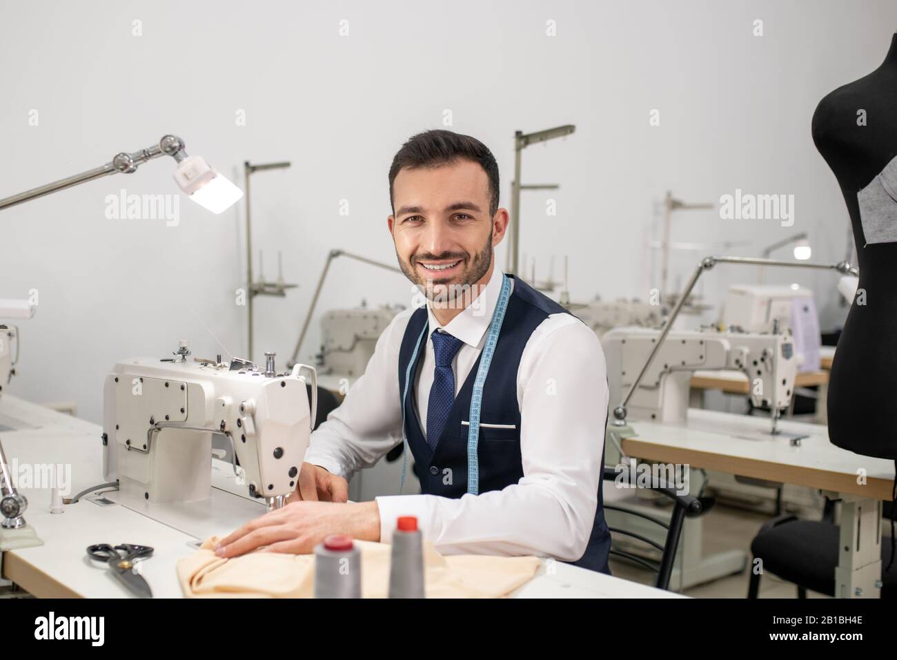 Tailor sitting hi-res stock photography and images - Alamy