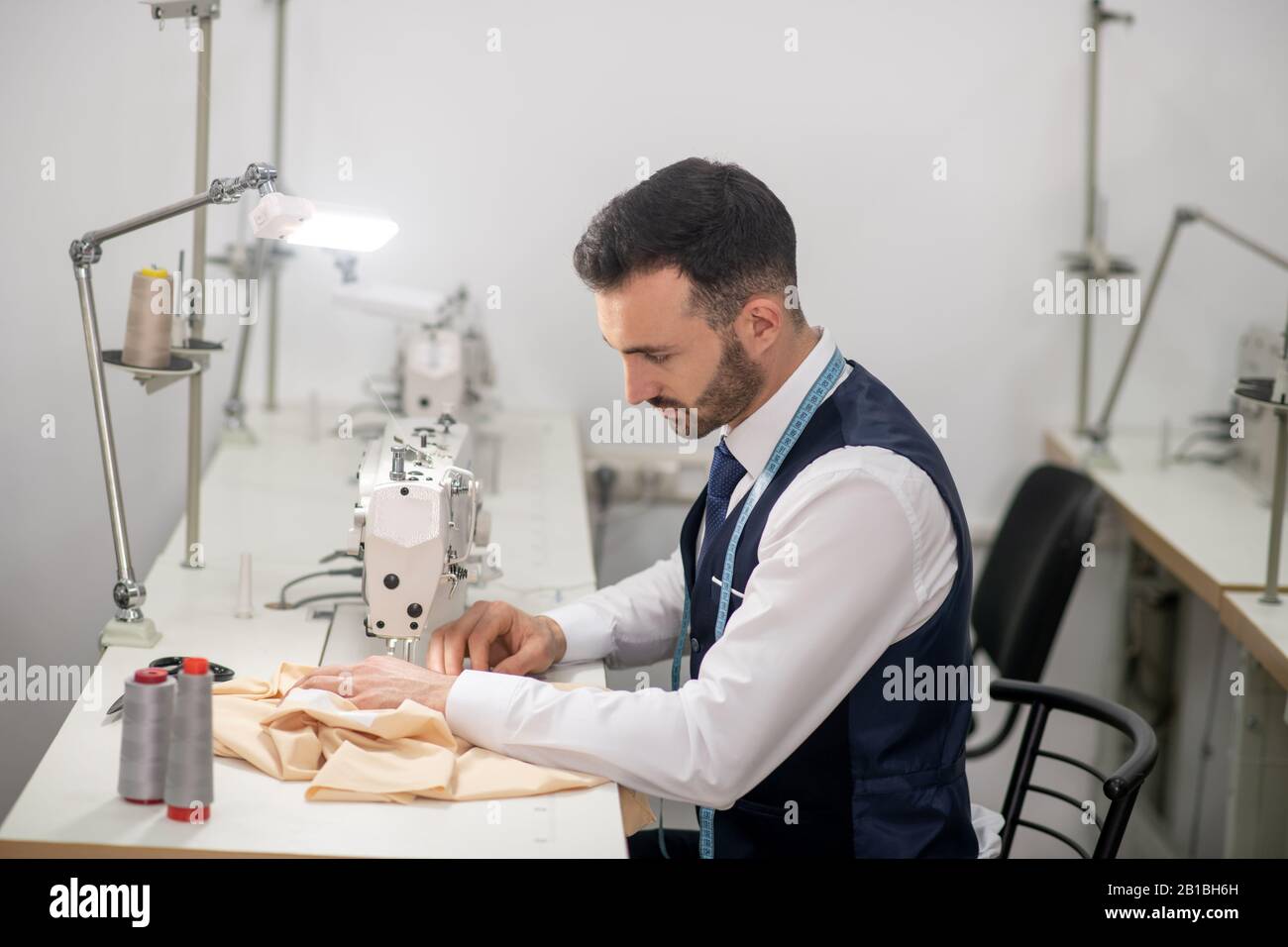 Tailor sitting hi-res stock photography and images - Alamy