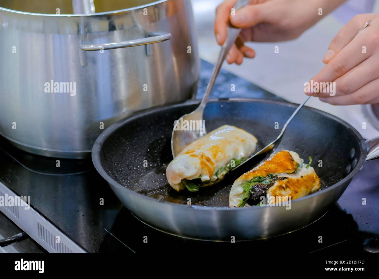 Chicken rolls with herbs frying in pan Stock Photo - Alamy
