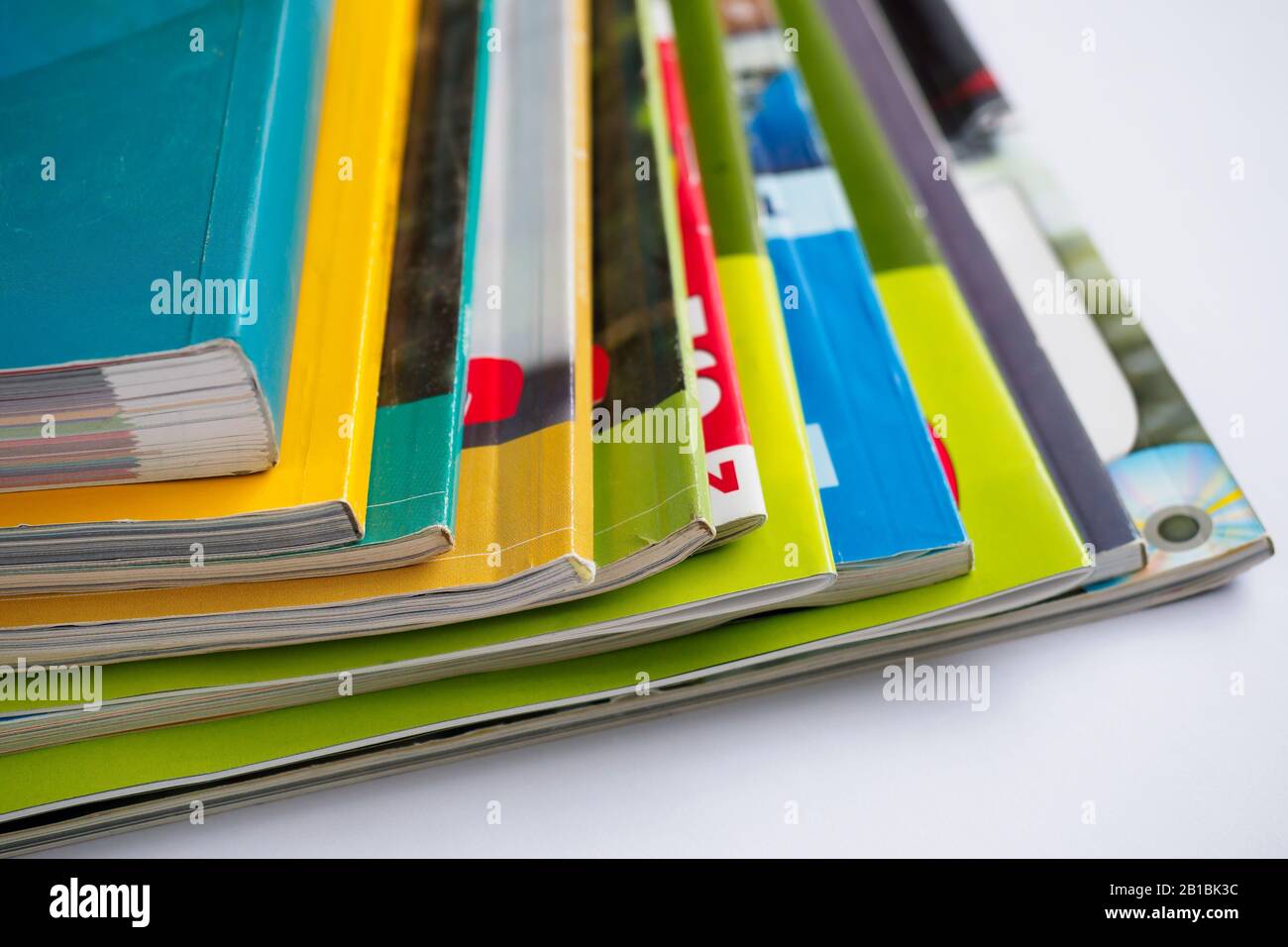 Stack of magazines on white background Stock Photo - Alamy