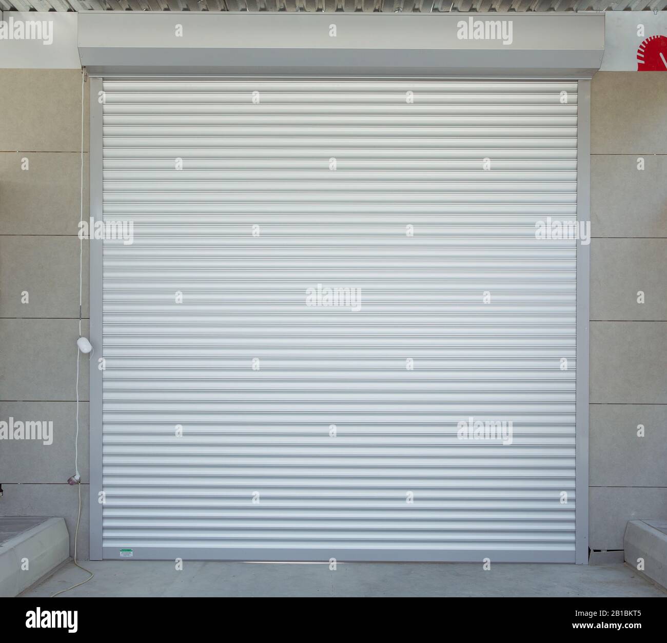 Shutter door or roller door and concrete floor outside .White Automatic ...